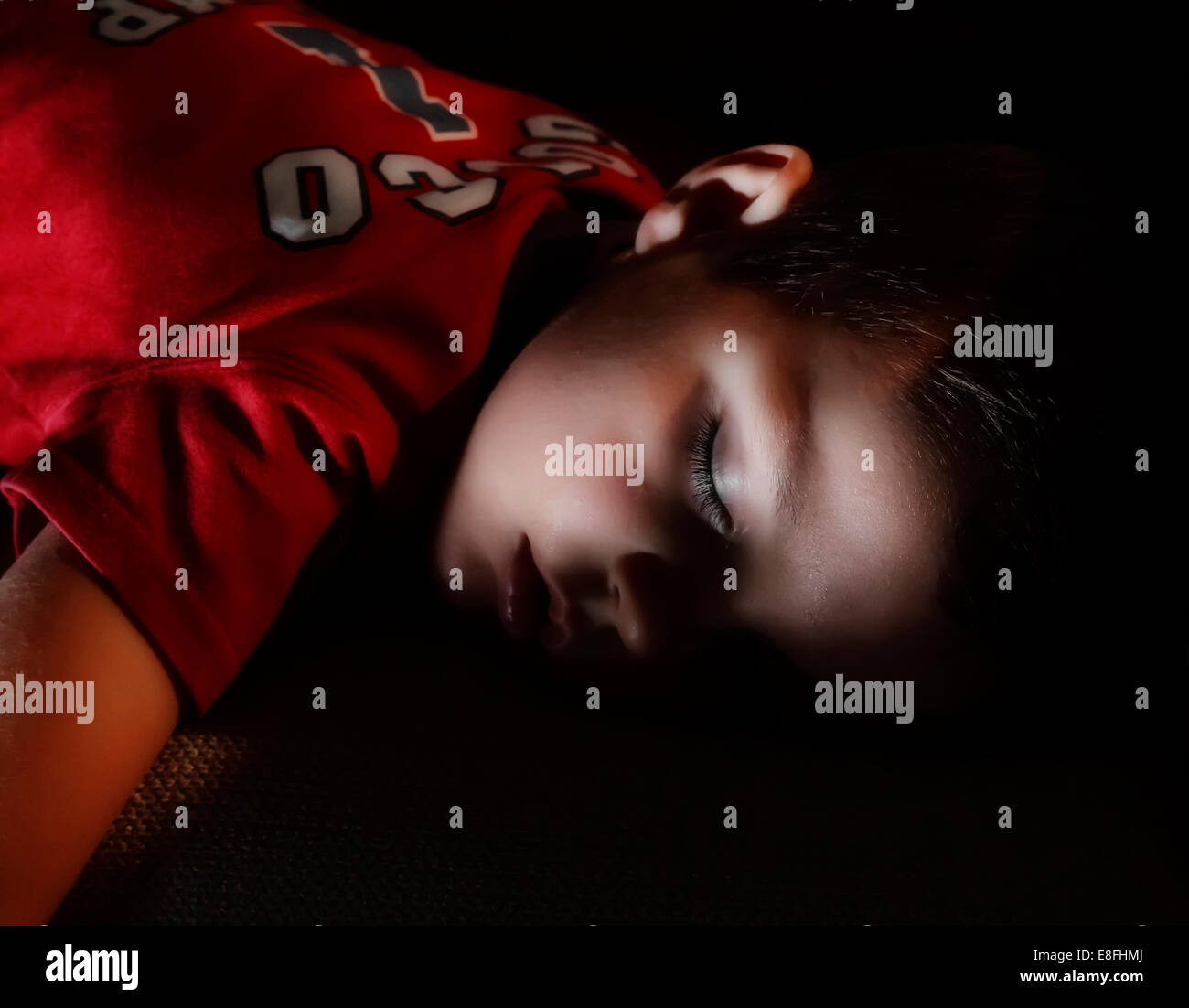 Boy sleeping on a sofa Stock Photo - Alamy