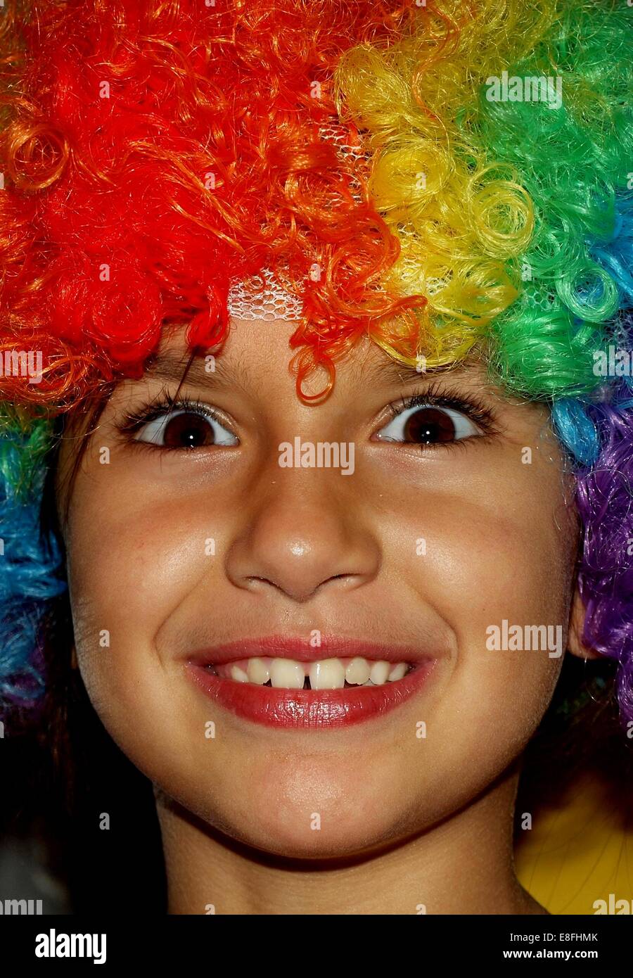 Girl wearing a multi coloured wig Stock Photo - Alamy