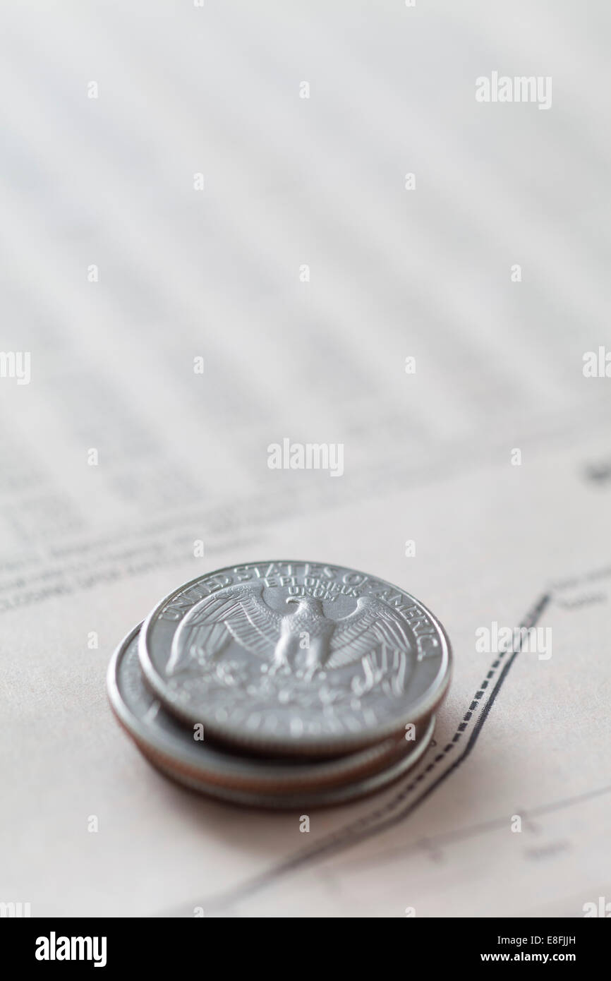 Stack of American quarters on financial graph Stock Photo - Alamy