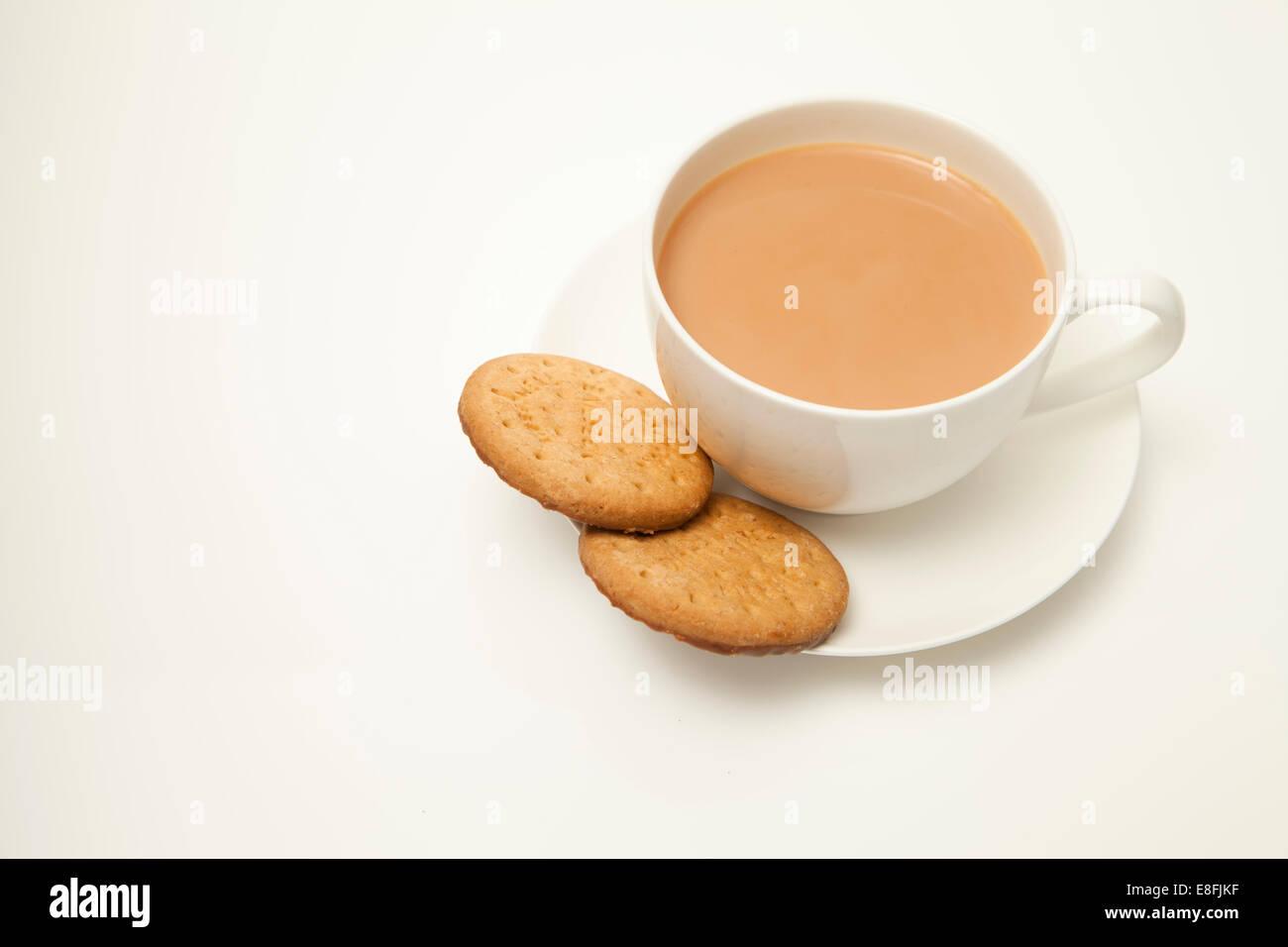 Close-Up of a cup of tea with milk and two digestive biscuits Stock ...
