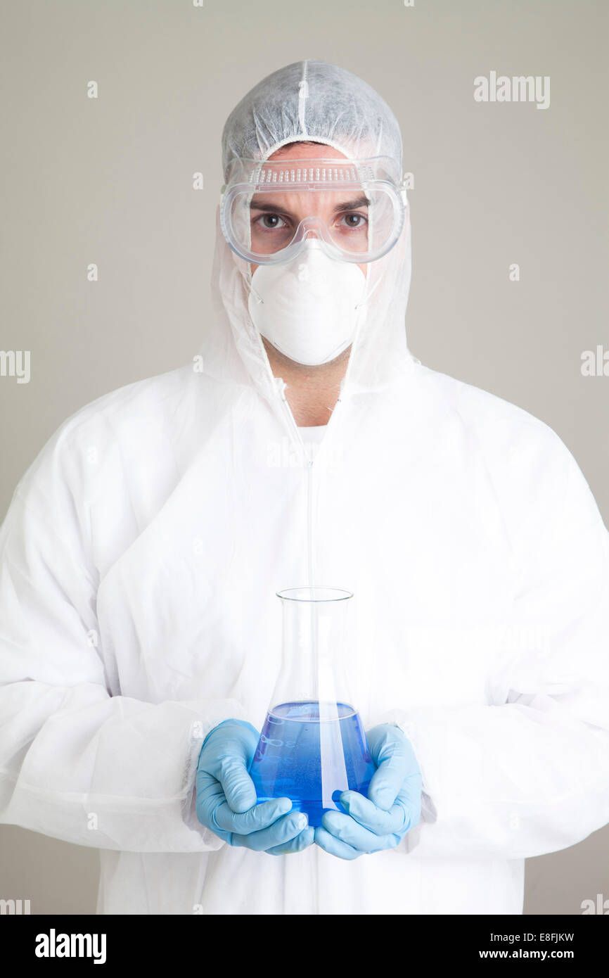 Scientist holding conical flask Stock Photo - Alamy