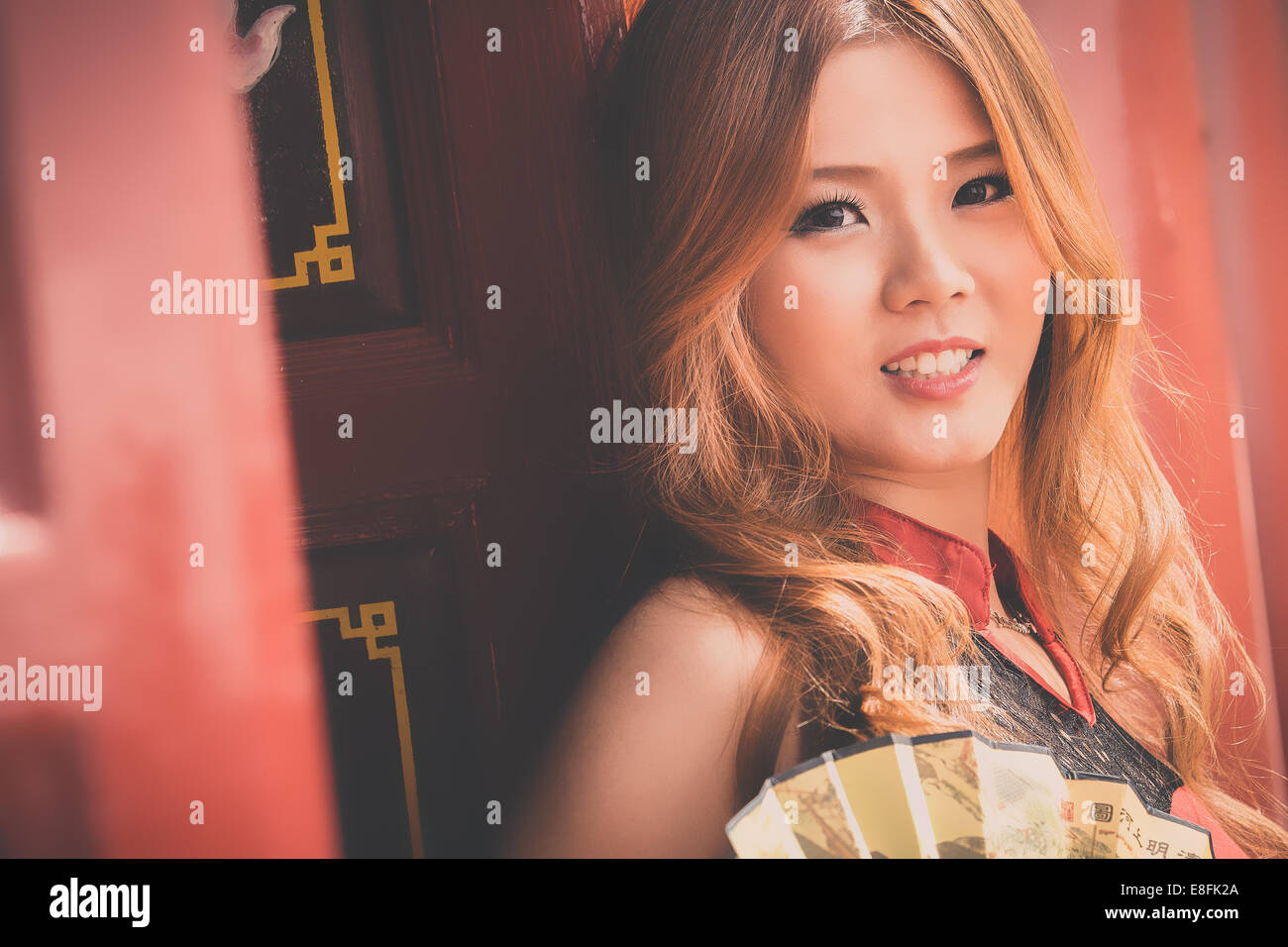 Portrait of young woman with fan Stock Photo - Alamy