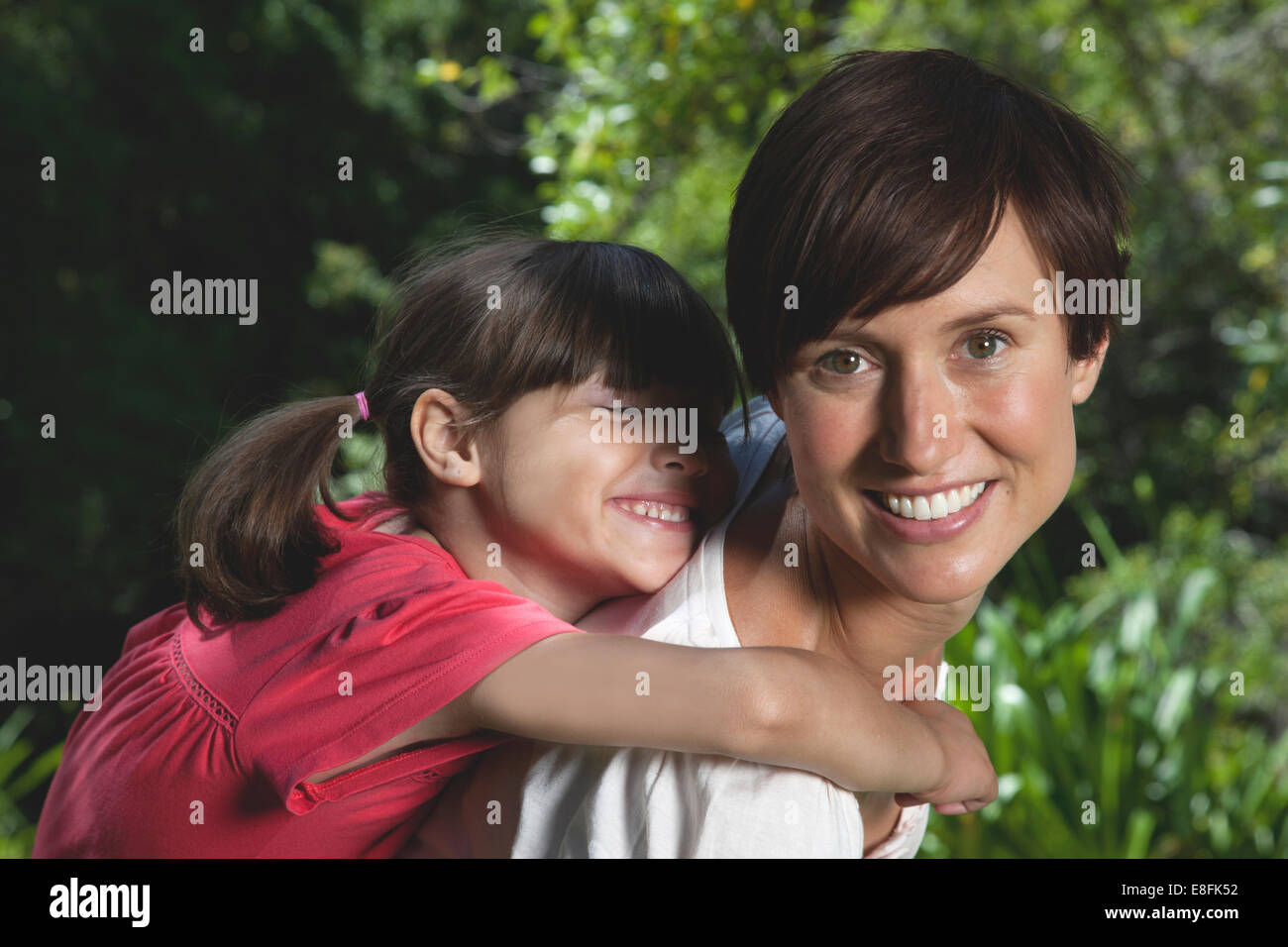 Daughter hugging her mother in park Stock Photo - Alamy