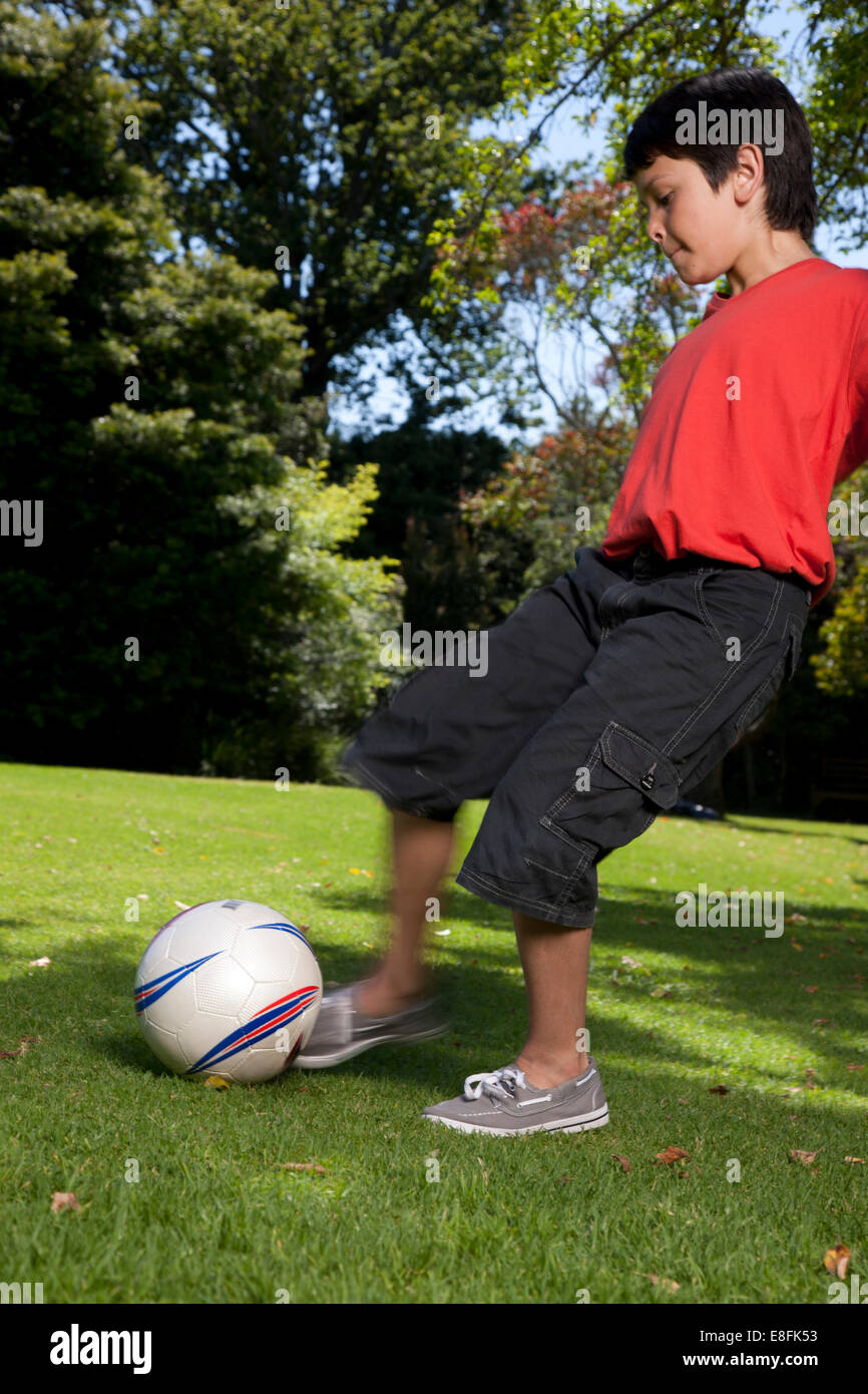 Boy Playing Football Stock Photo - Alamy