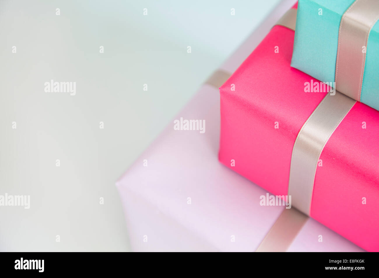 Close-up of a stack of Three wrapped gifts Stock Photo - Alamy