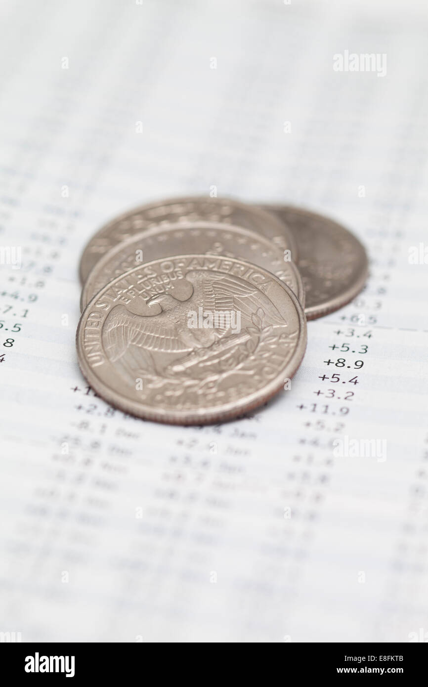 Close-up of a stack of American quarters on a document with financial ...
