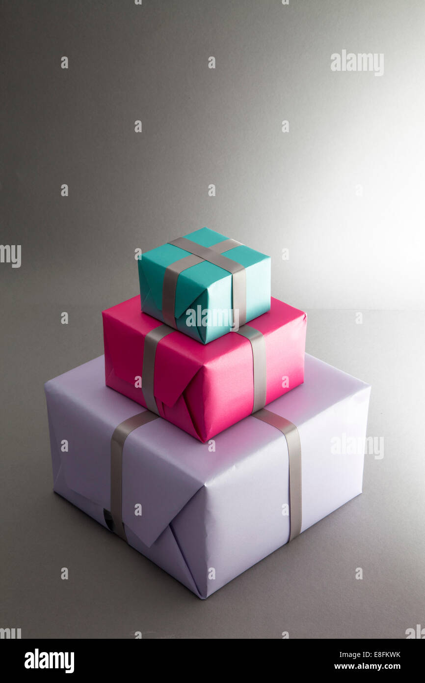 Close-up of a stack of Three wrapped gifts Stock Photo - Alamy