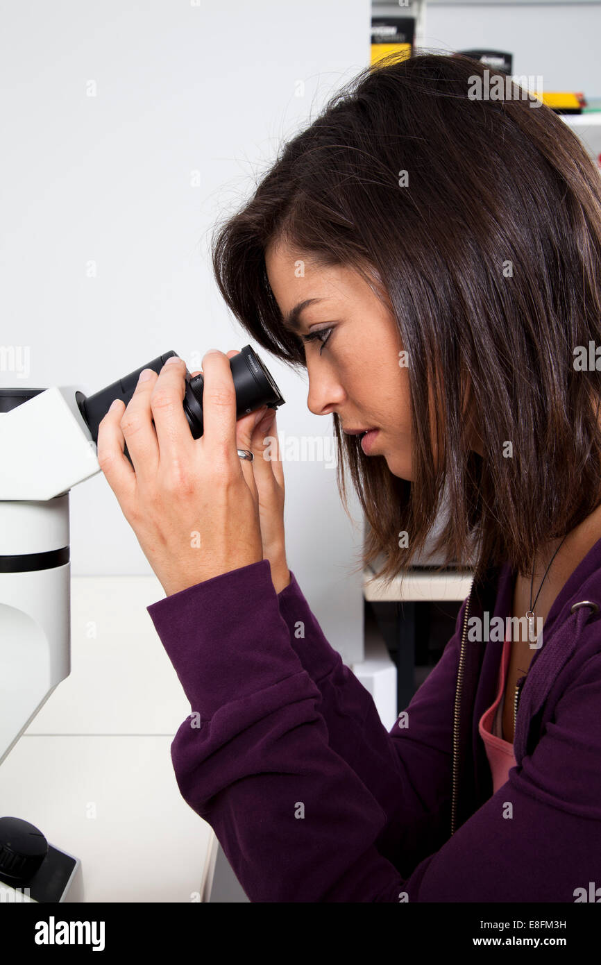Young Woman Using Microscope Stock Photo - Alamy