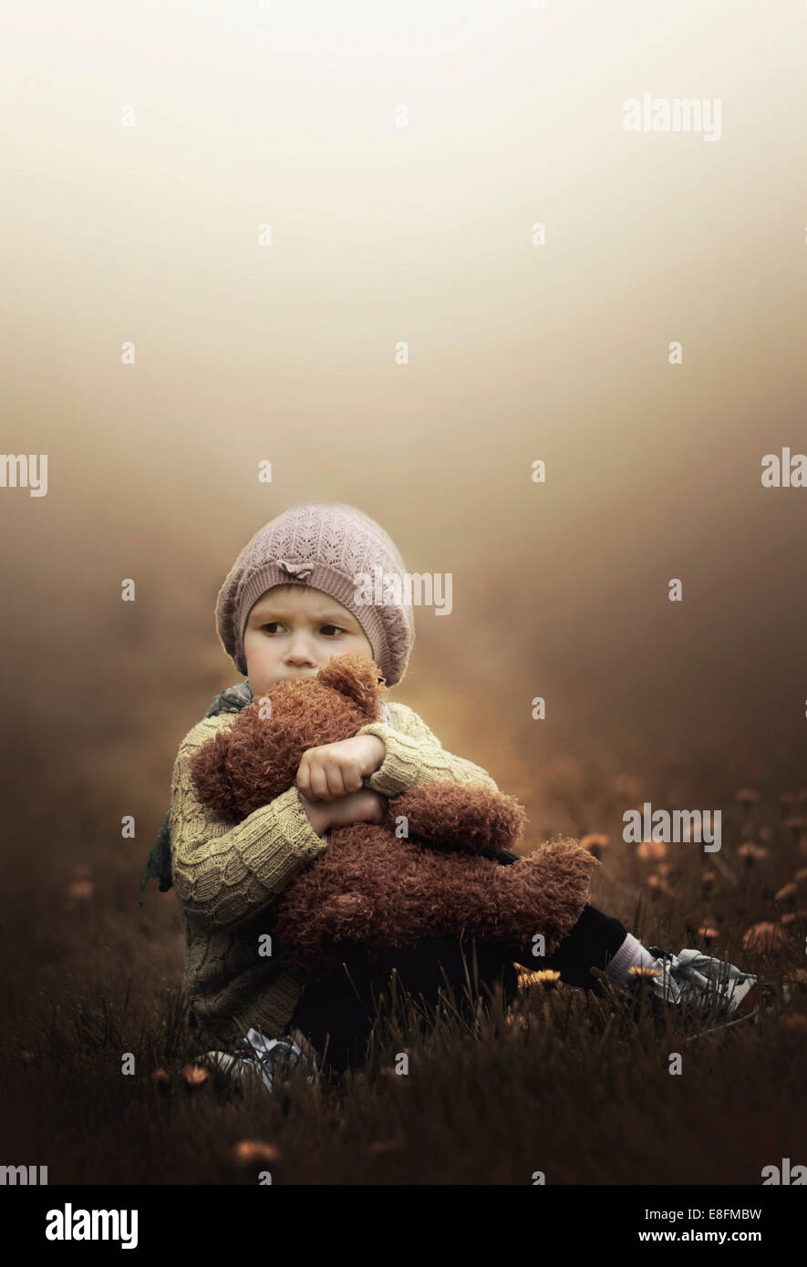 Girl cuddling teddy bear Stock Photo - Alamy