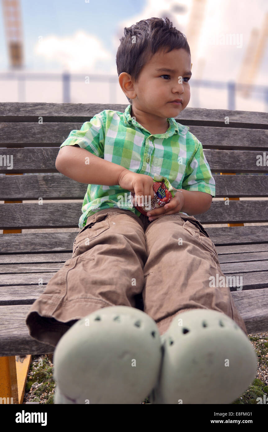 Child sitting on bench hi-res stock photography and images - Alamy