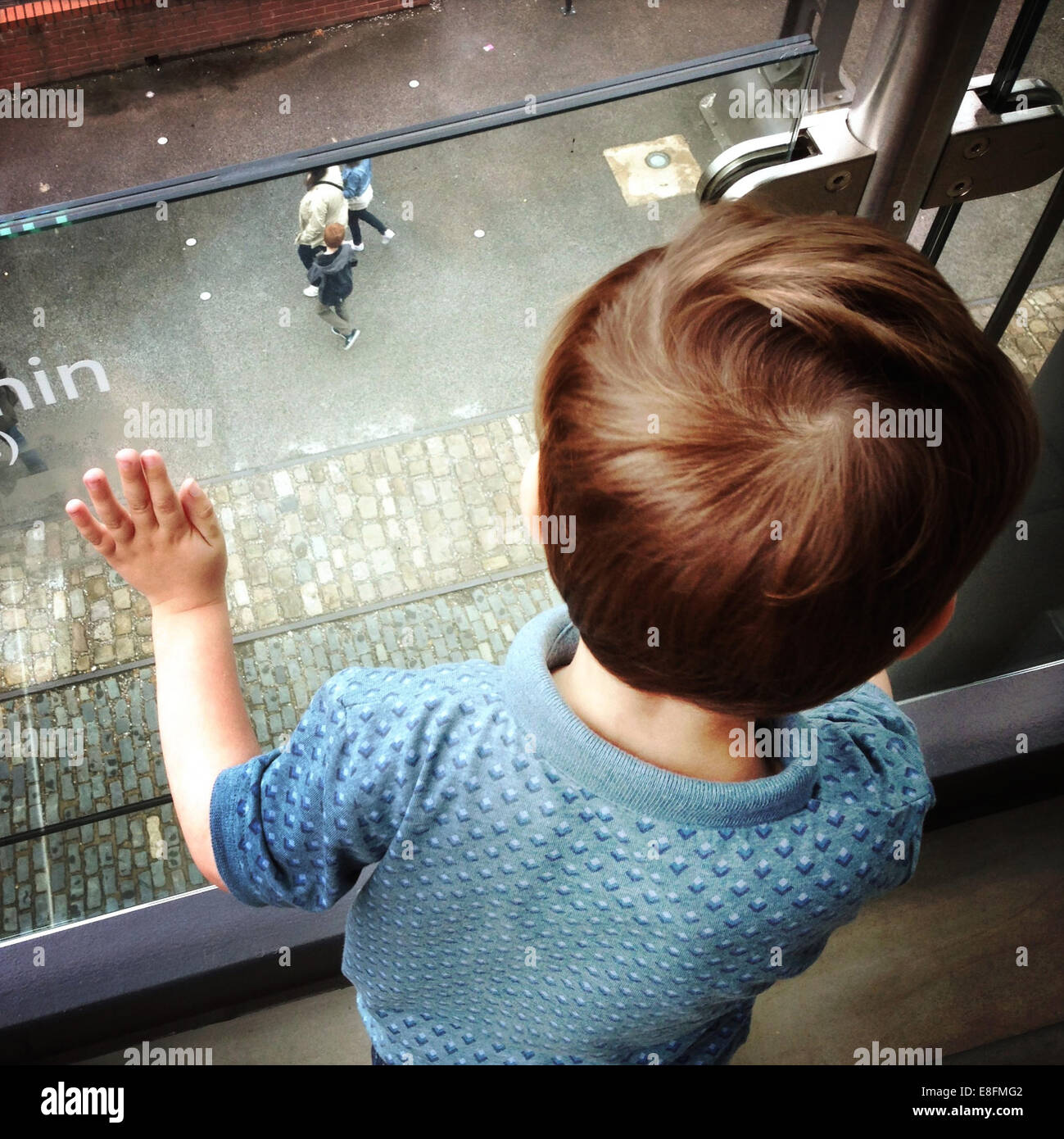 United Kingdom, England, Manchester, Child watching people from above ...
