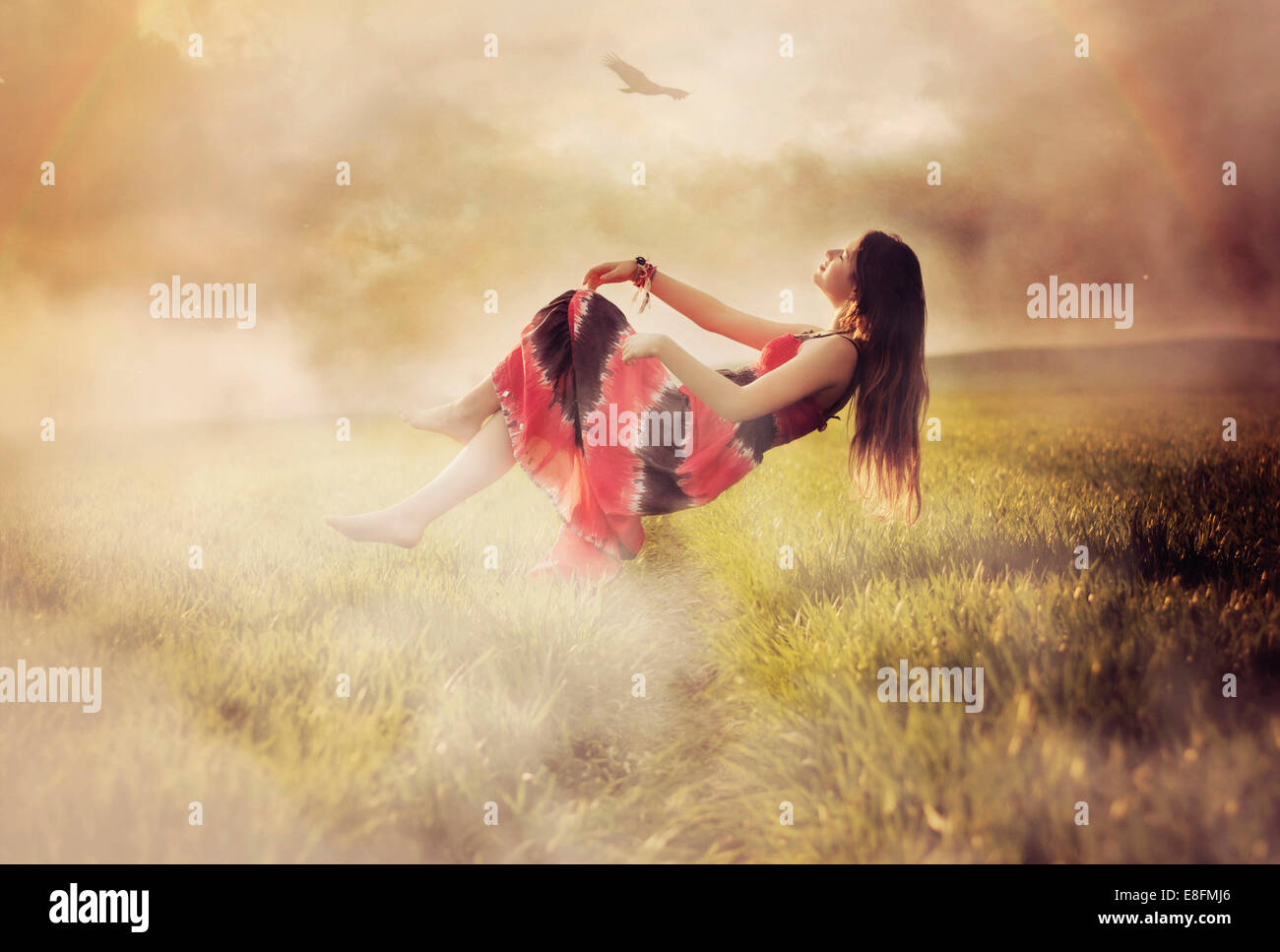 Woman floating above a meadow, Poland Stock Photo - Alamy
