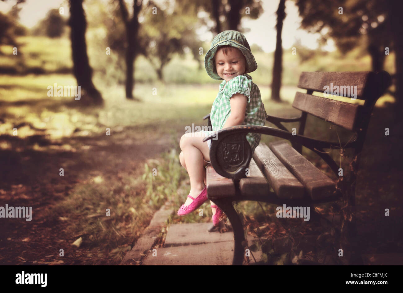 Girl on Bench Stock Photo - Alamy