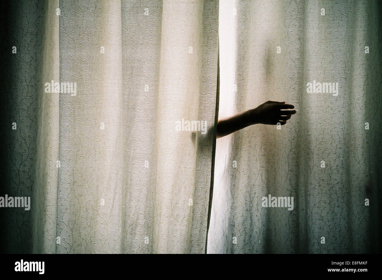 Man's Hand reaching from behind a curtain Stock Photo - Alamy