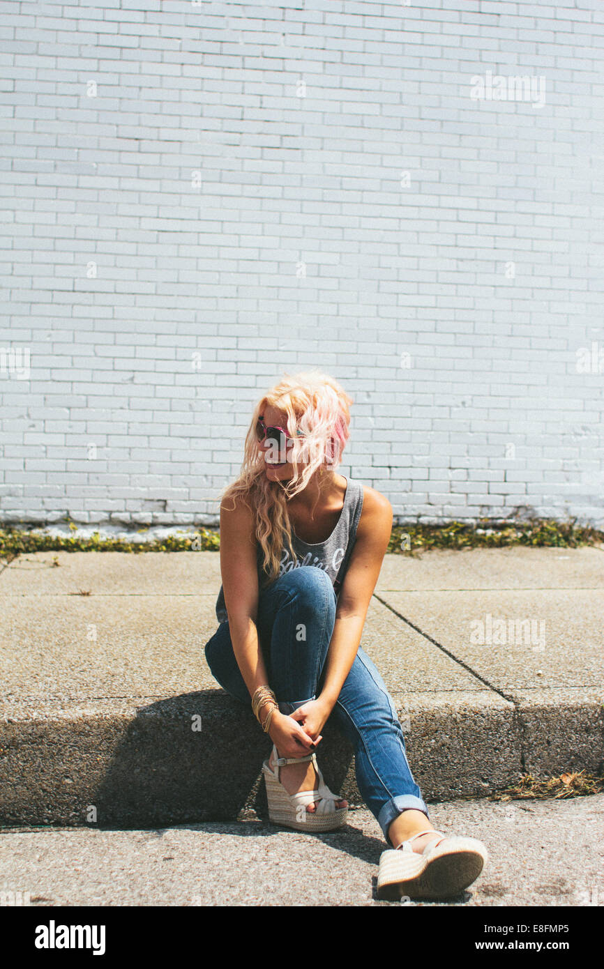 Young Woman Sitting On Curb Stock Photos & Young Woman Sitting On Curb ...