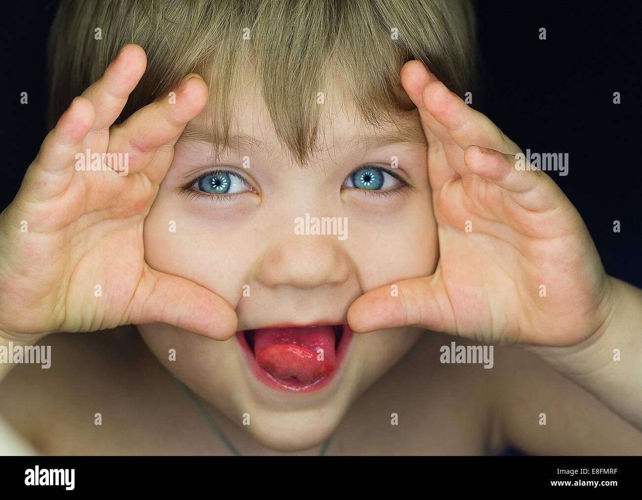 Portrait of a boy pulling funny faces Stock Photo - Alamy