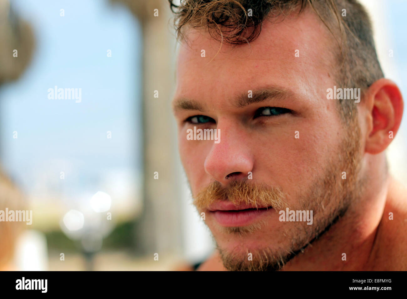 Portrait of young man sitting in sun Stock Photo - Alamy