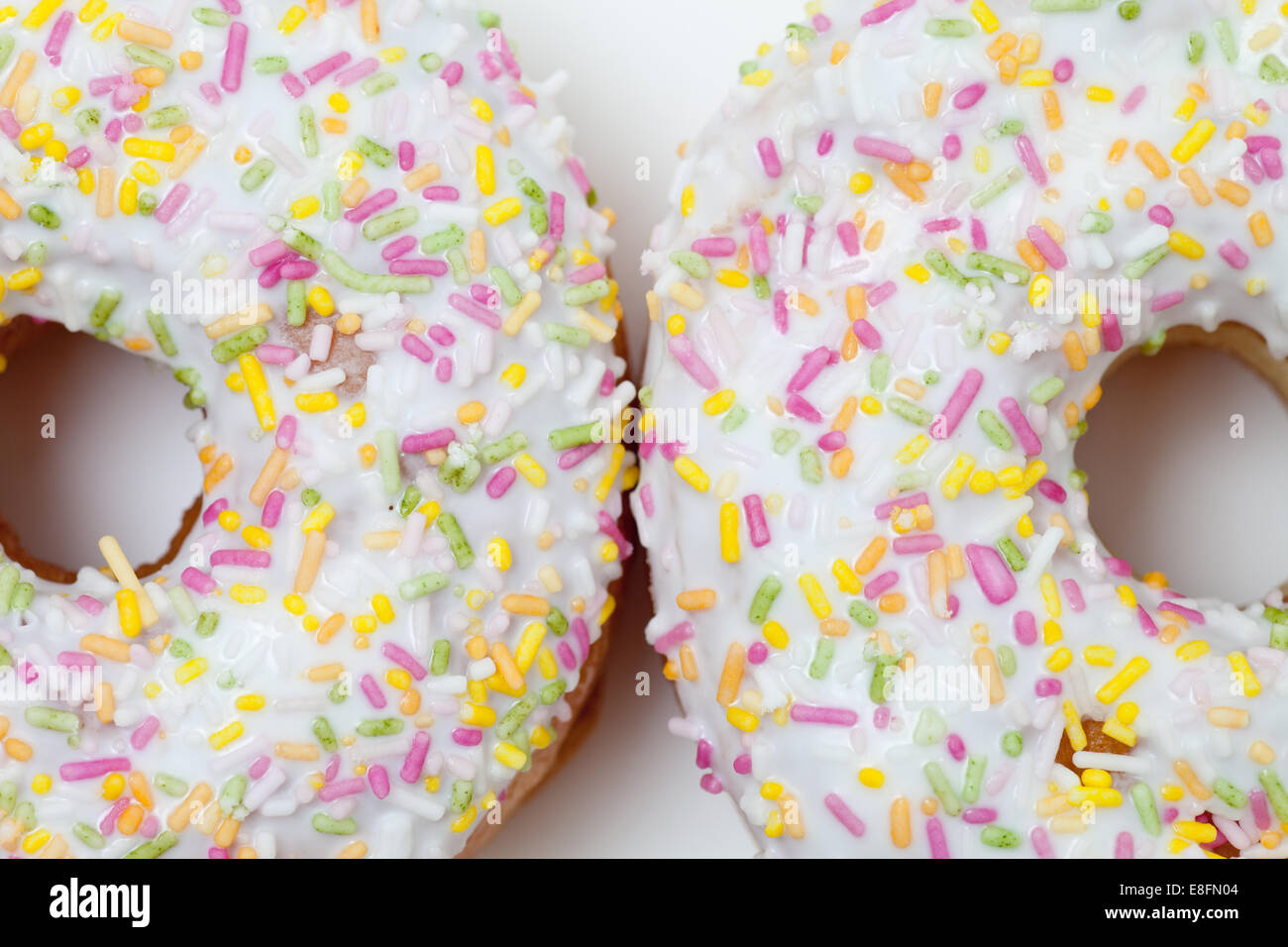 Two iced doughnuts with icing and multi coloured sprinkles Stock Photo ...