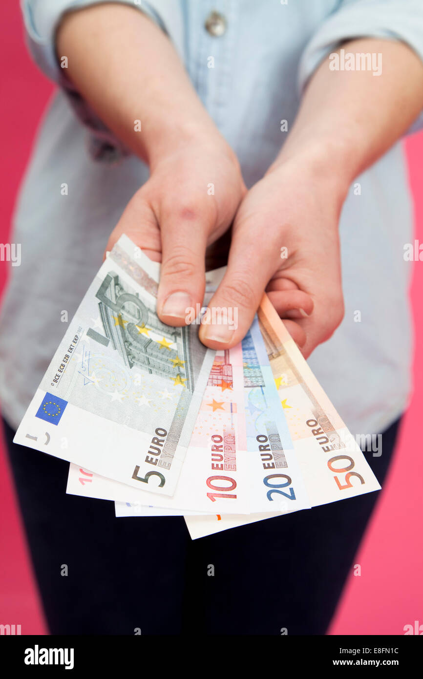 Close up of woman holding euro banknotes Stock Photo - Alamy