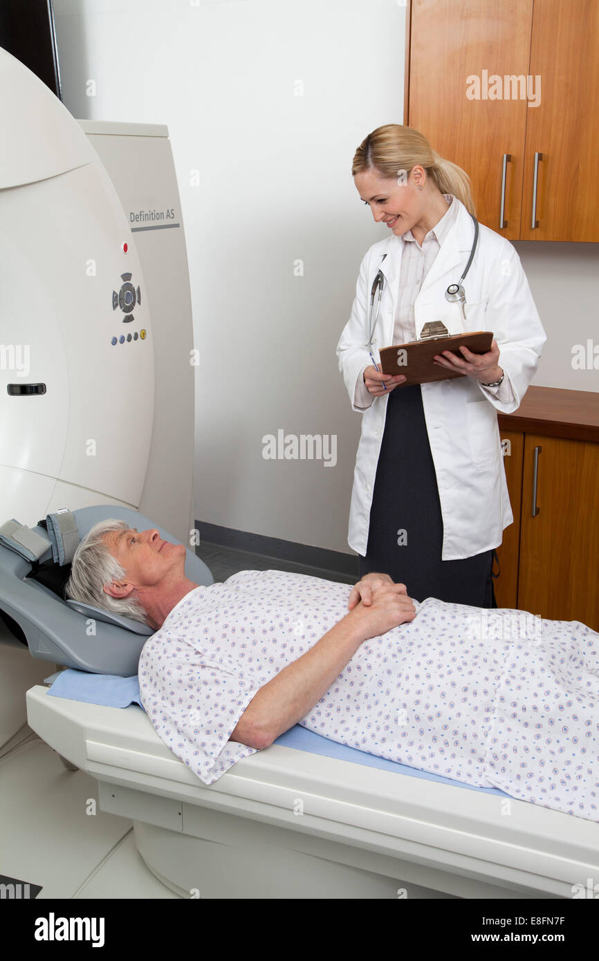Female doctor with male patient next to MRI Scanner Stock Photo - Alamy