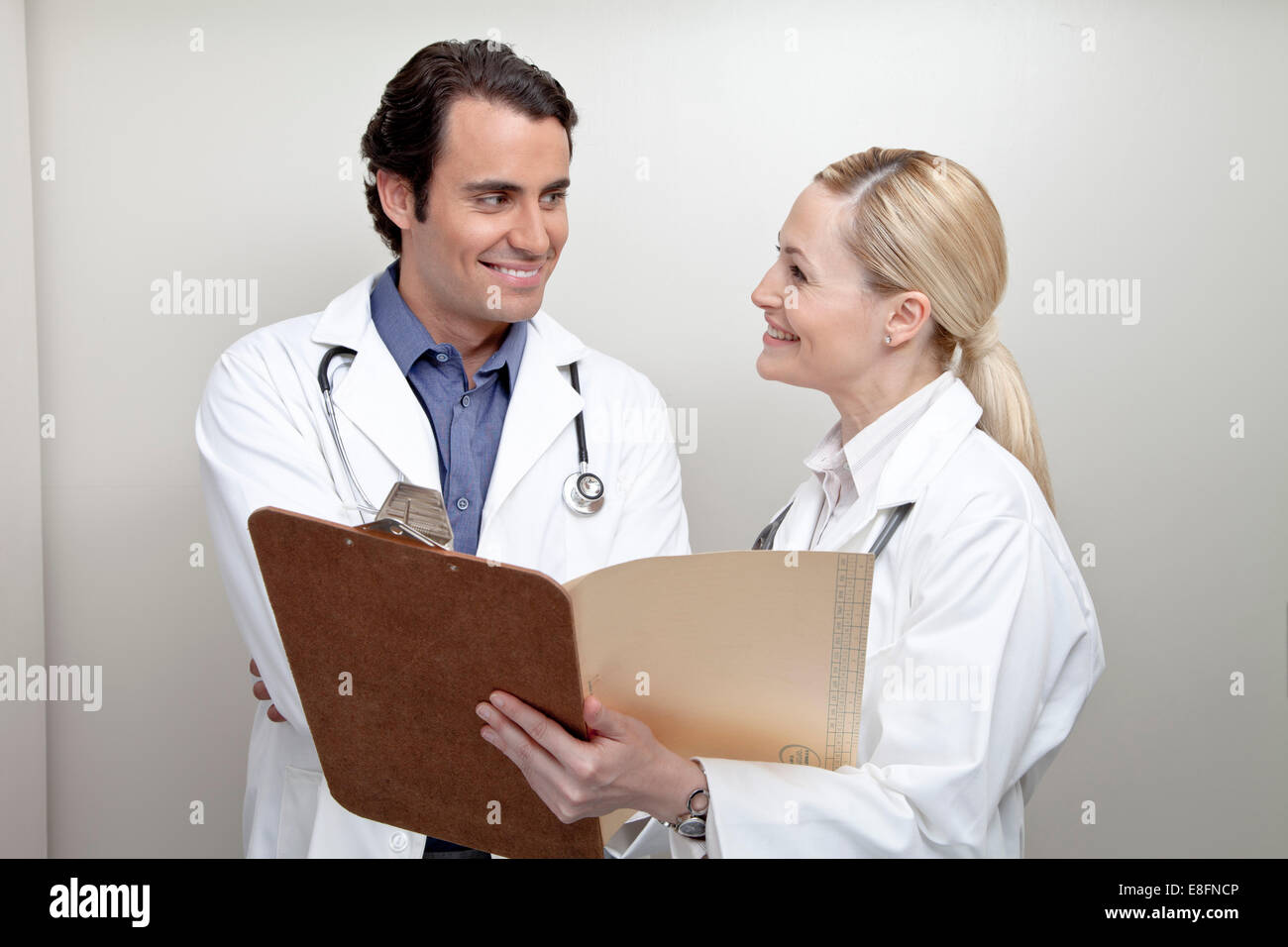 Two doctors discussing medical notes Stock Photo - Alamy