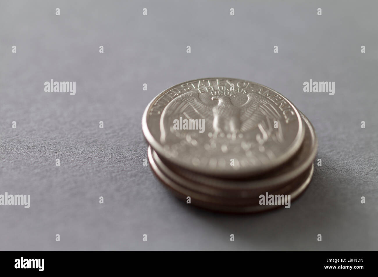 Close-up of a stack of quarters on a table Stock Photo - Alamy