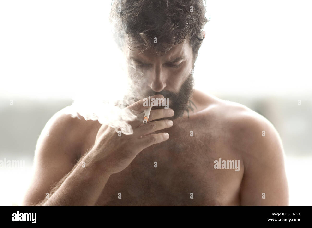 Portrait of a man smoking a cigarette Stock Photo - Alamy