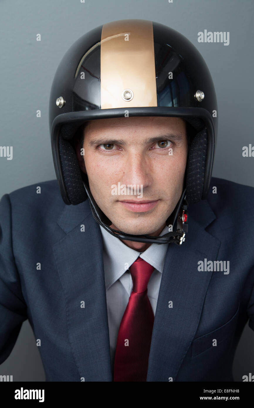 Businessman wearing crash helmet Stock Photo - Alamy