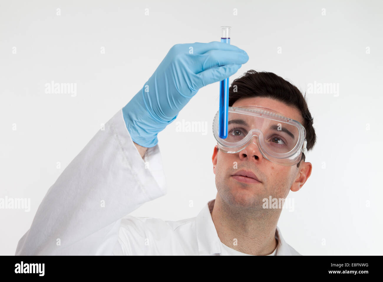 Male Scientist looking at test tube Stock Photo - Alamy
