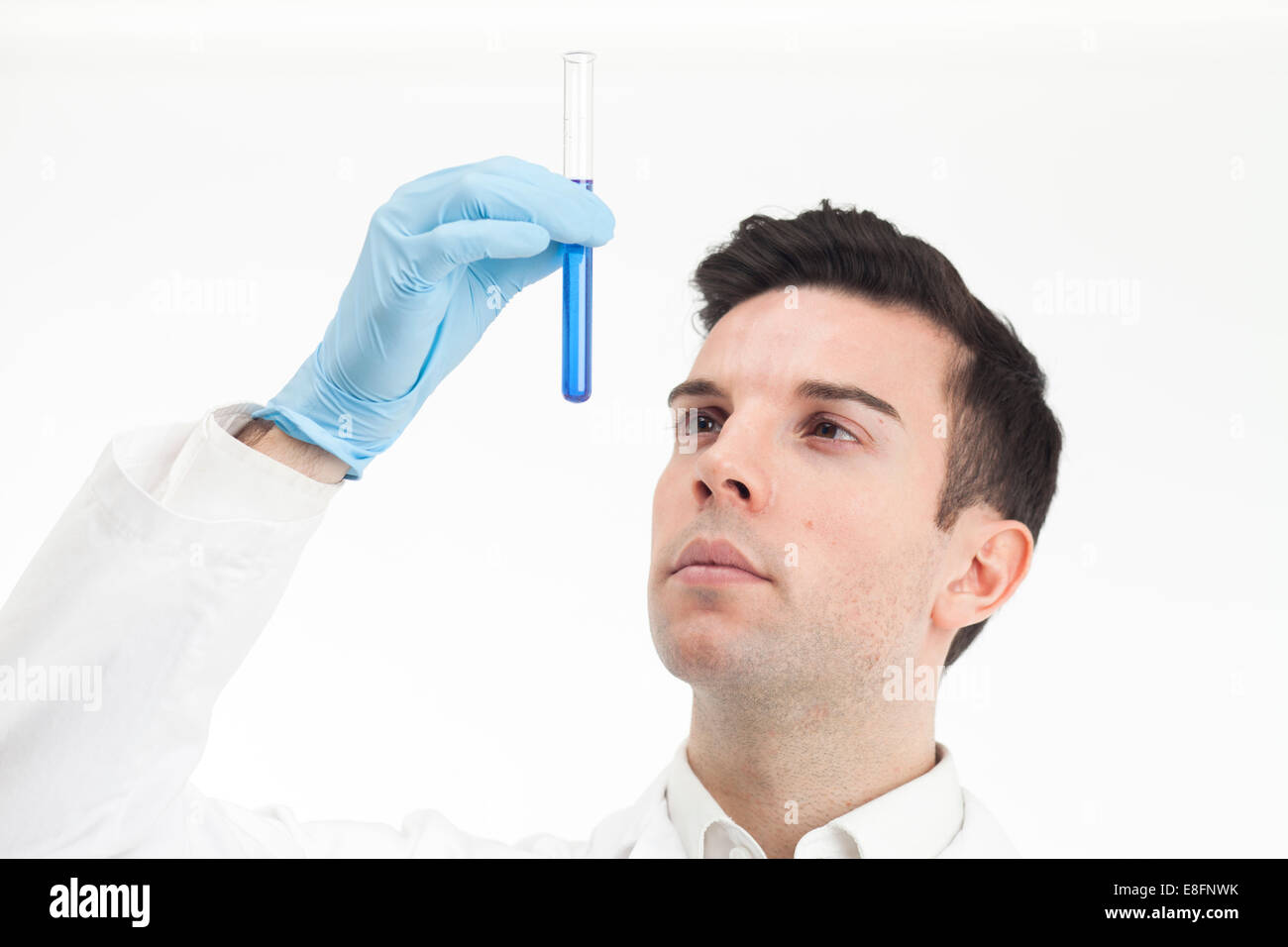 Male Scientist looking at test tube Stock Photo - Alamy