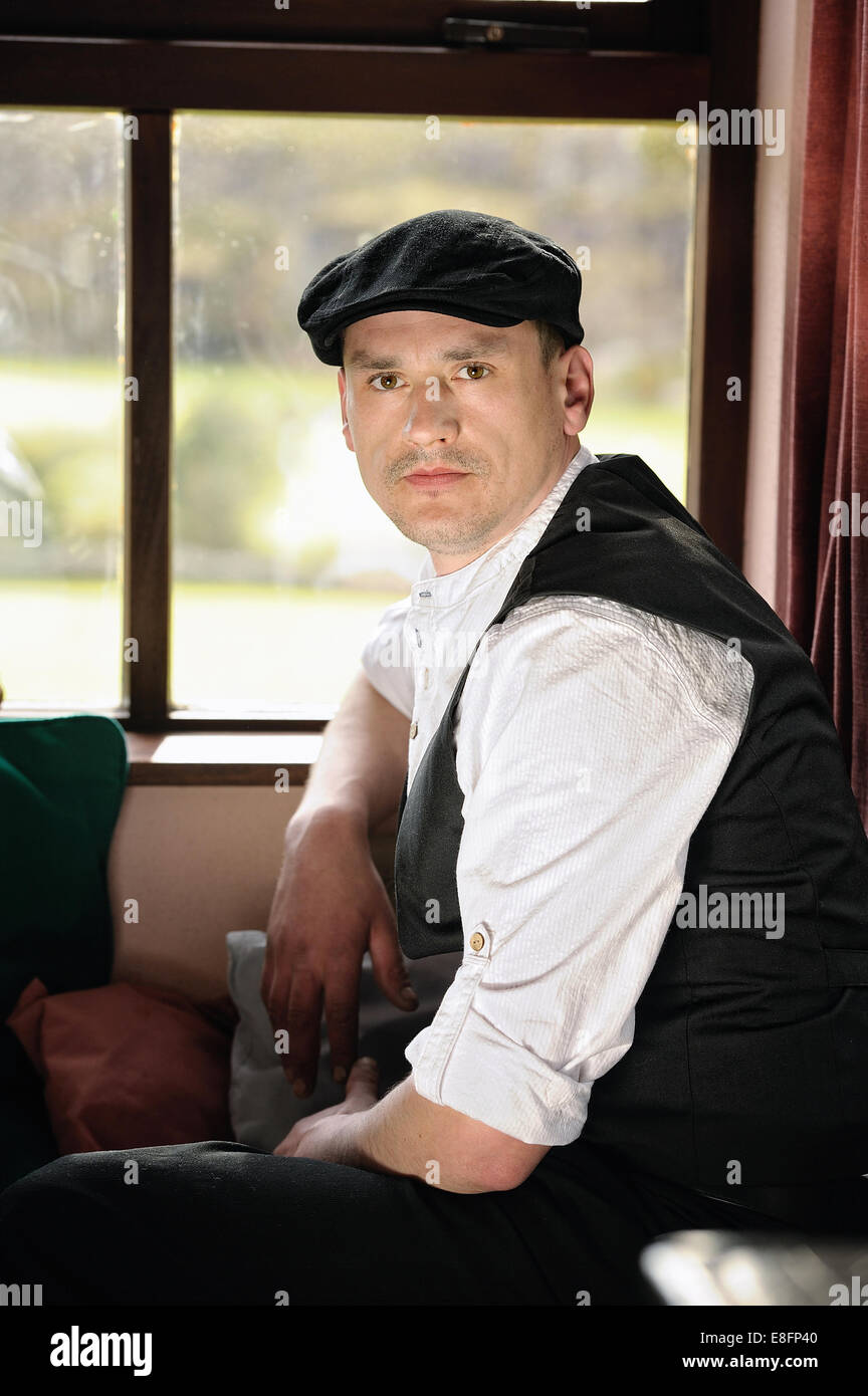 Man sitting at window Stock Photo - Alamy