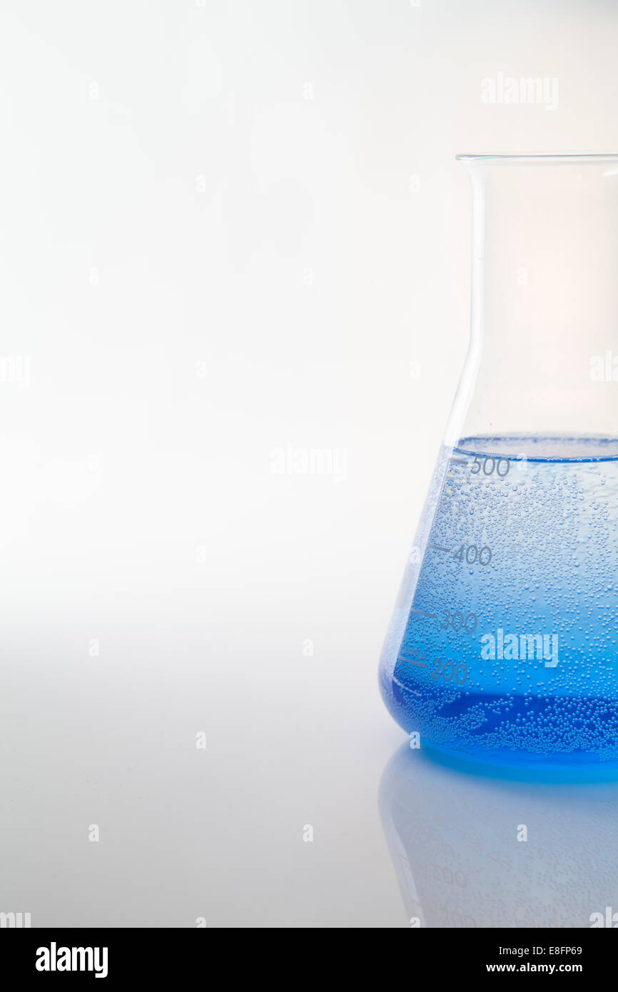 Close up of conical flask with blue liquid Stock Photo - Alamy