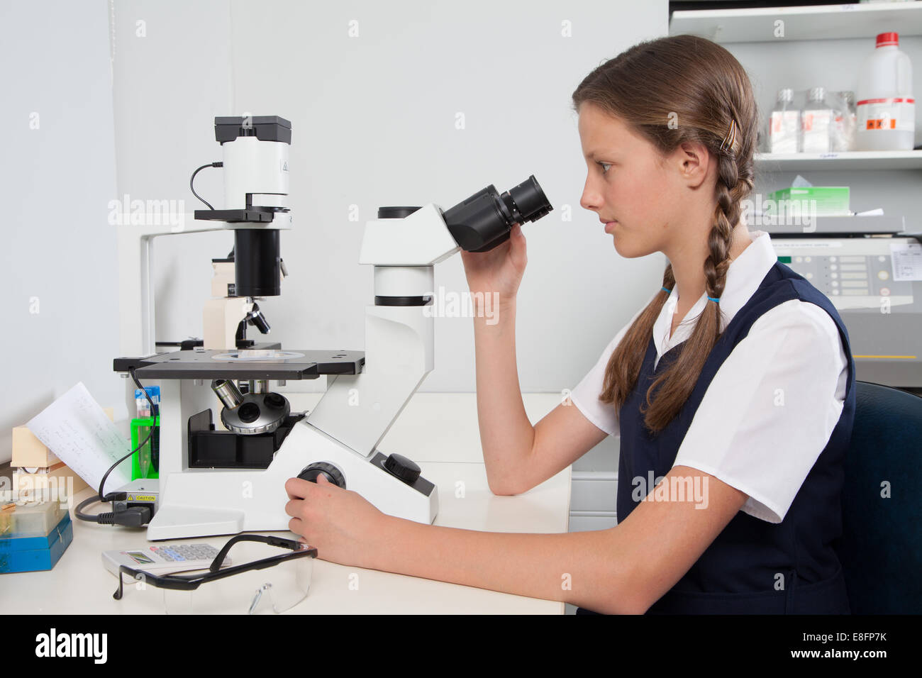 Student girl looking in a microscope hi-res stock photography and ...