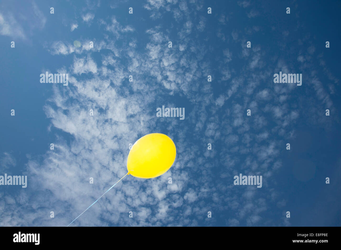 Yellow balloon flying in the sky Stock Photo - Alamy