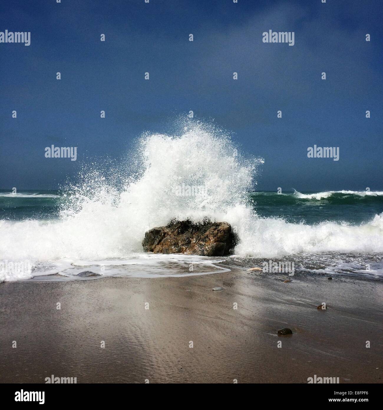 Wave crashing against rock on the beach, Portugal Stock Photo - Alamy