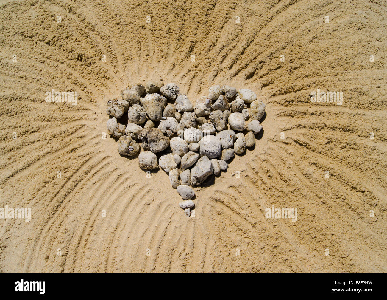 Heart stone in sand hi-res stock photography and images - Alamy