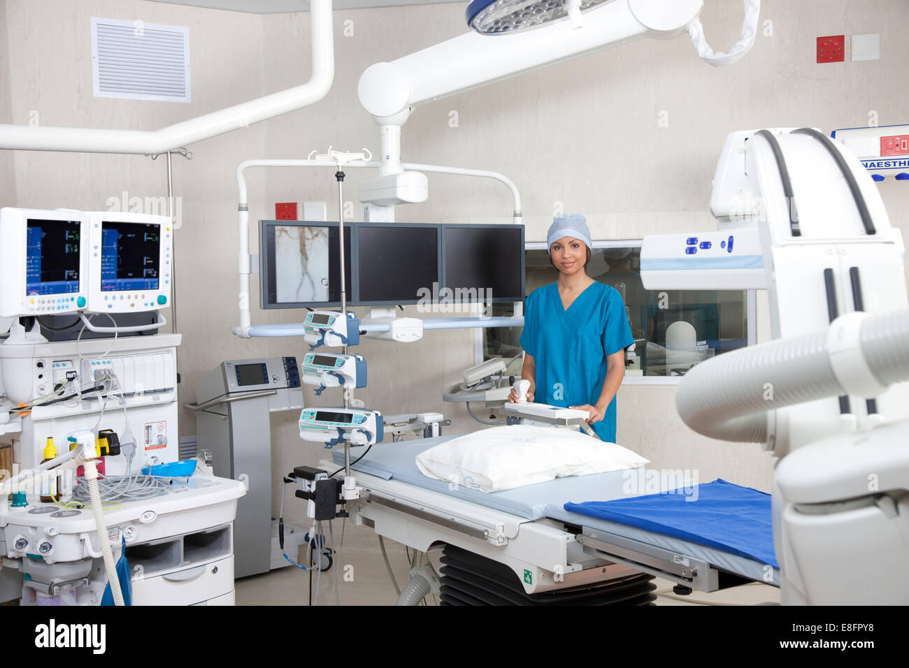 Nurse in operating theatre with robotic imaging system Stock Photo - Alamy