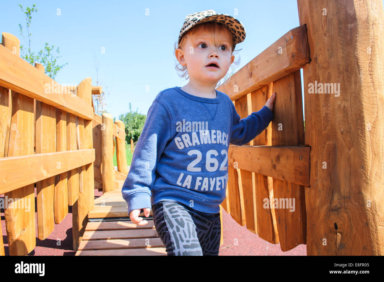 Boy walking across a wooden bridge Stock Photo - Alamy