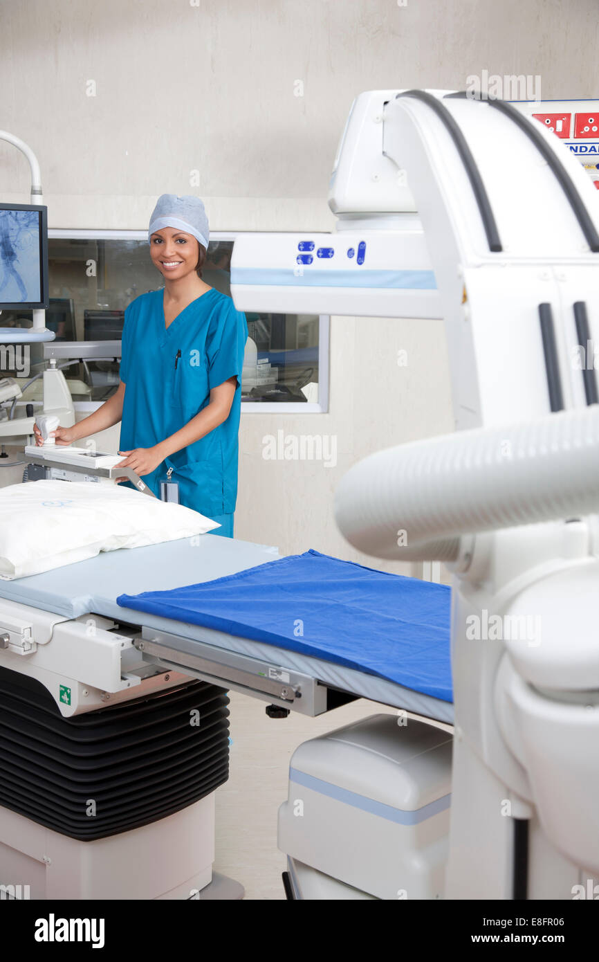 Doctor standing in operating room with robotic imaging system Stock ...