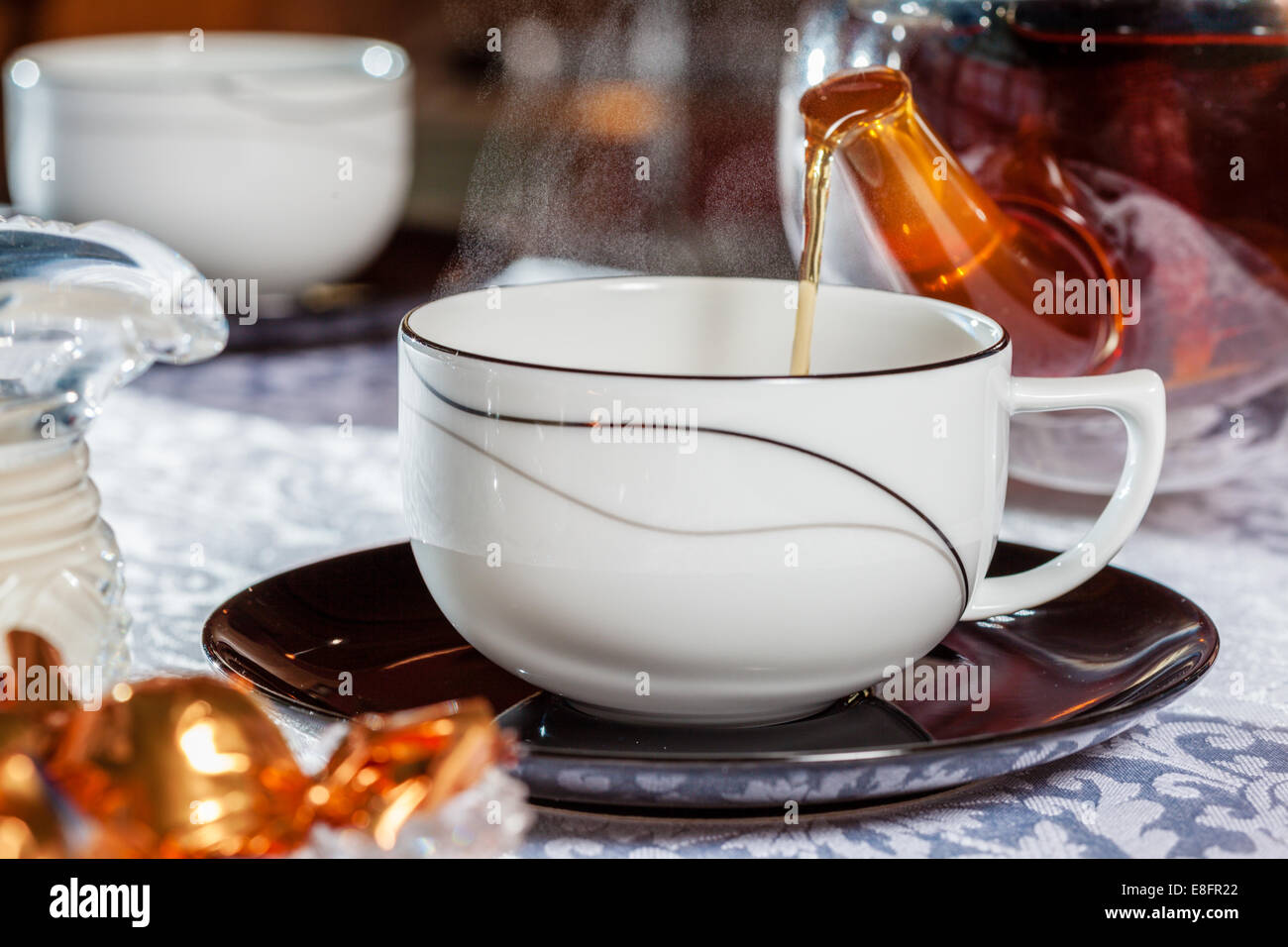 Pouring black tea Stock Photo - Alamy