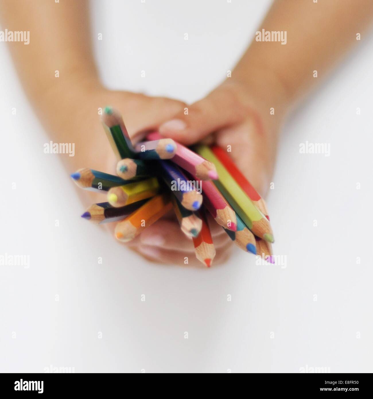 4 hands one pencil hi-res stock photography and images - Alamy