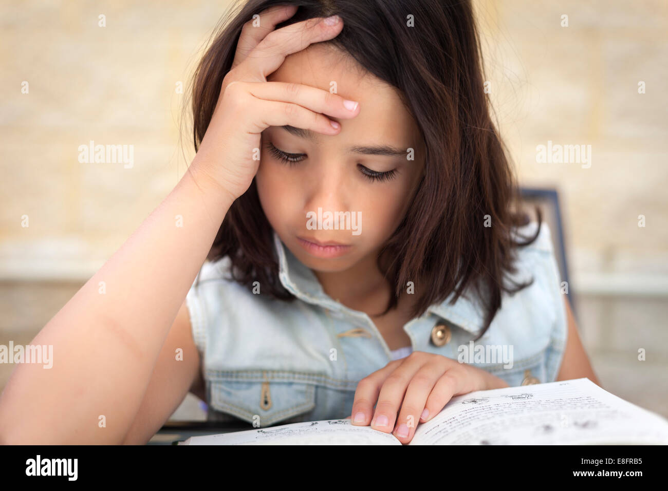 Close-up portrait of a girl reading book Stock Photo - Alamy