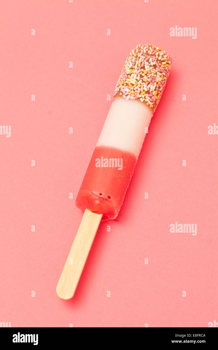 Ice Lolly with sprinkles on a pink background Stock Photo - Alamy