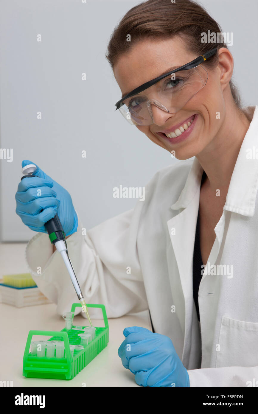 Lab technician pipetting samples in research laboratory Stock Photo - Alamy