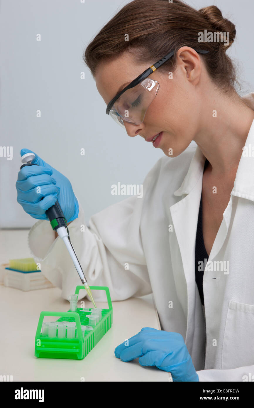 Lab technician pipetting samples in research laboratory Stock Photo - Alamy