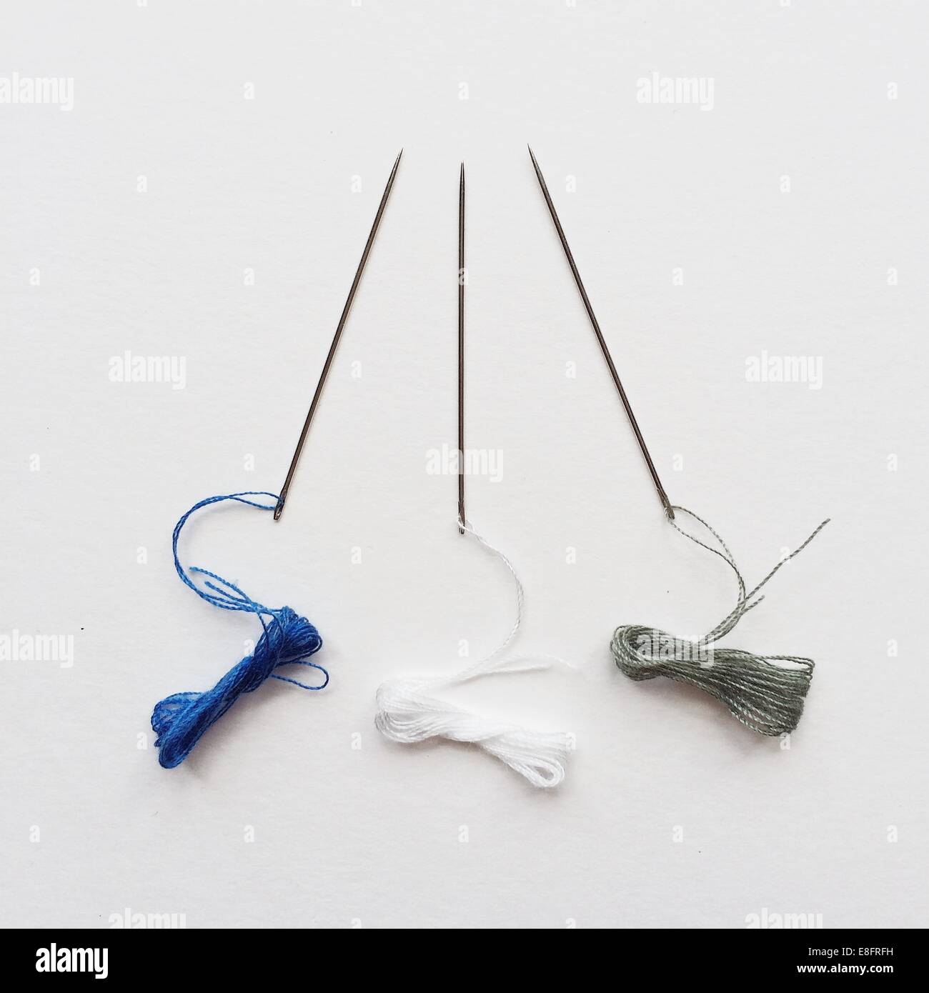 Three sewing needles with thread Stock Photo - Alamy