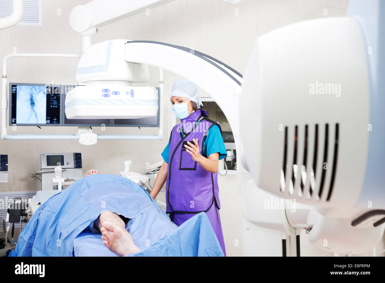 Medical technician talking patient through an MRI scan in operating ...