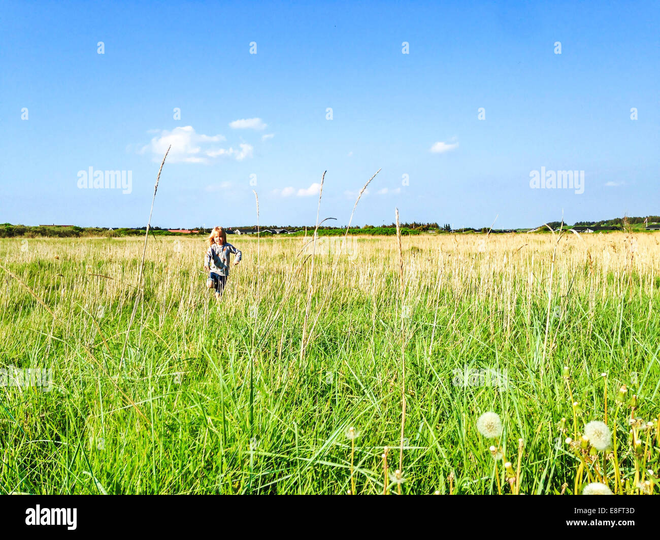 Child running through the field hi-res stock photography and images - Alamy