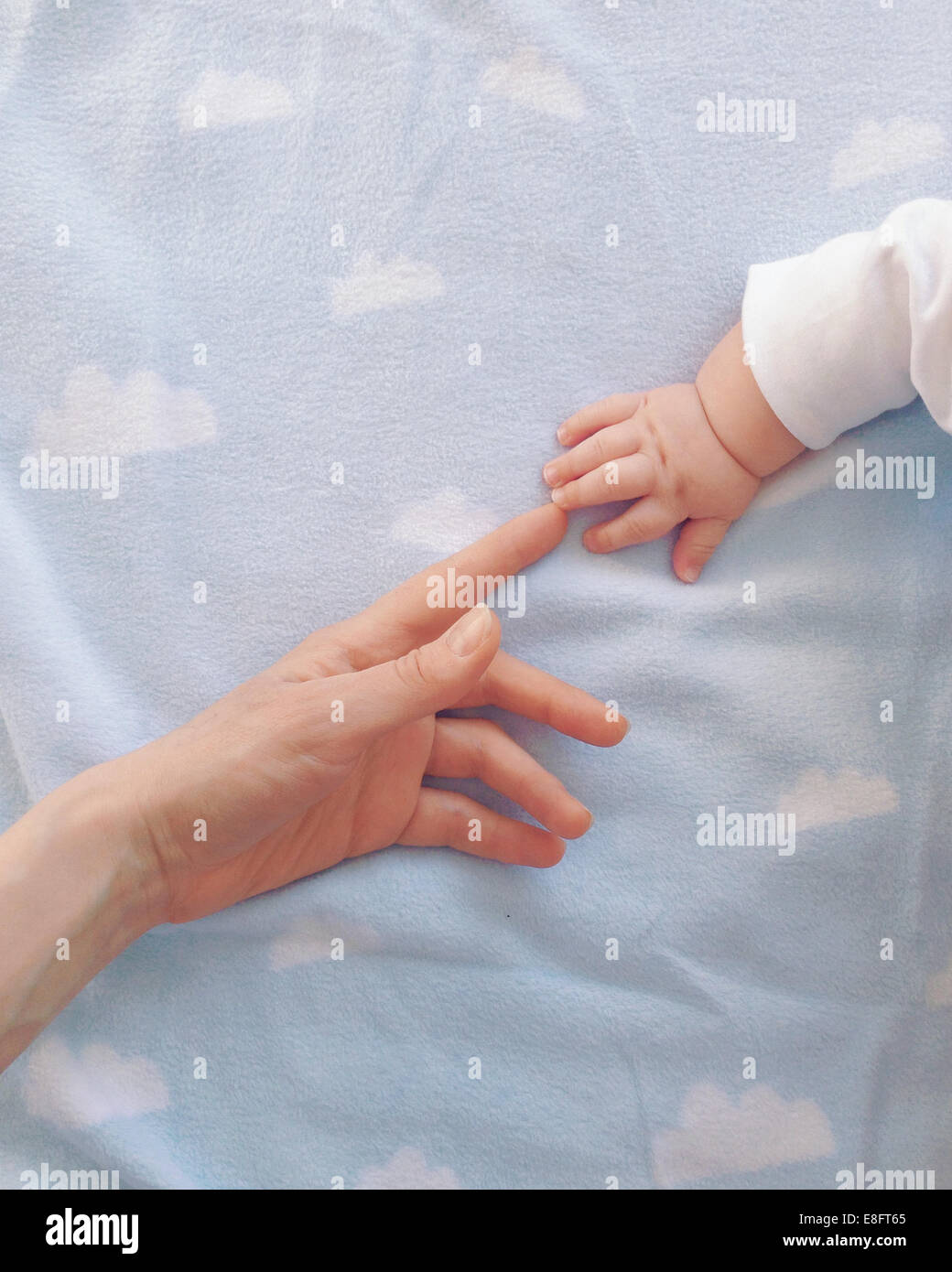 Mother and baby touching fingers Stock Photo - Alamy