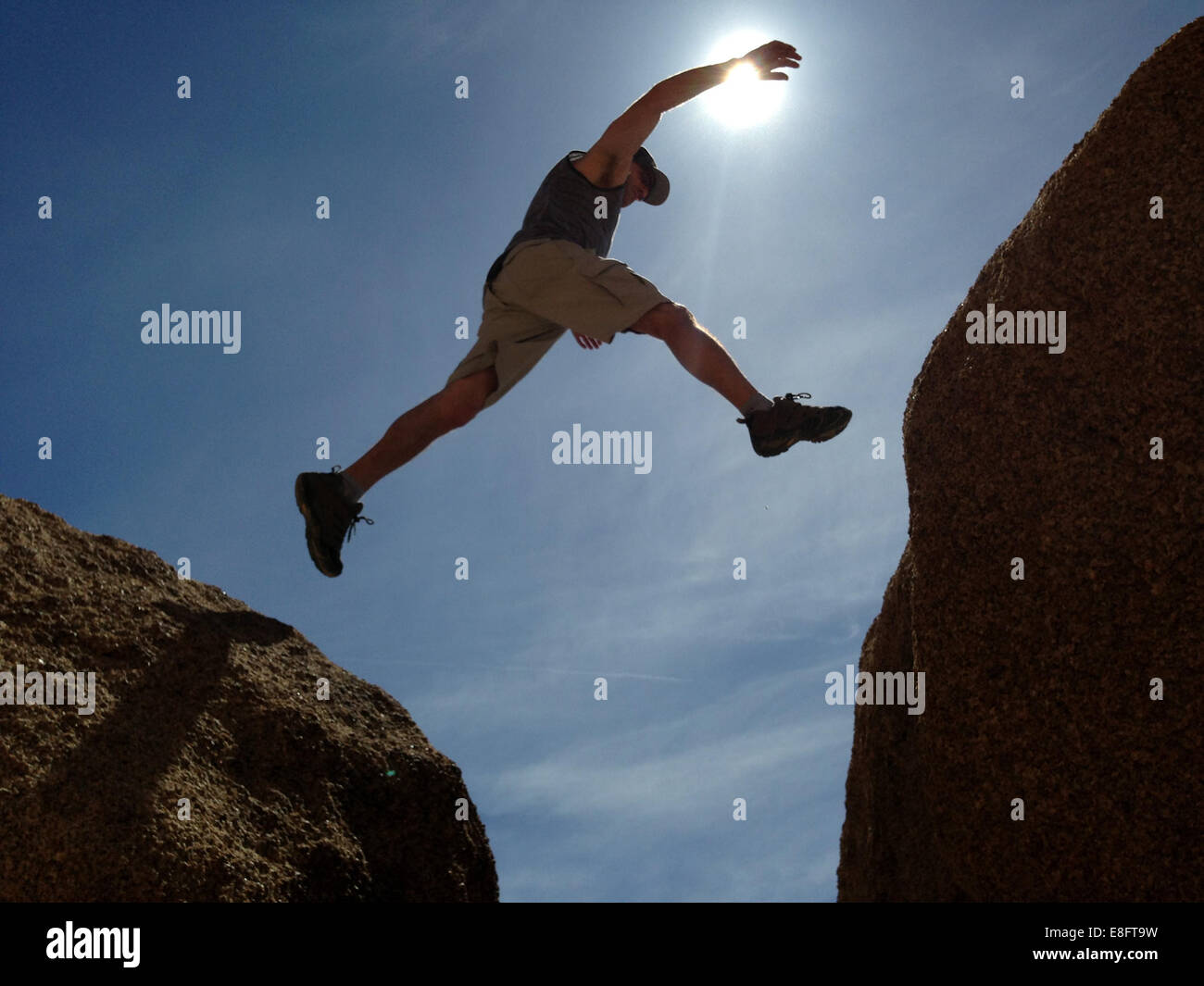 Man jumping between rocks Stock Photo - Alamy
